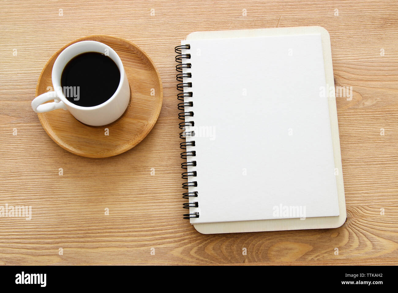 Open notebook with empty pages over wooden old office desk table. Top ...