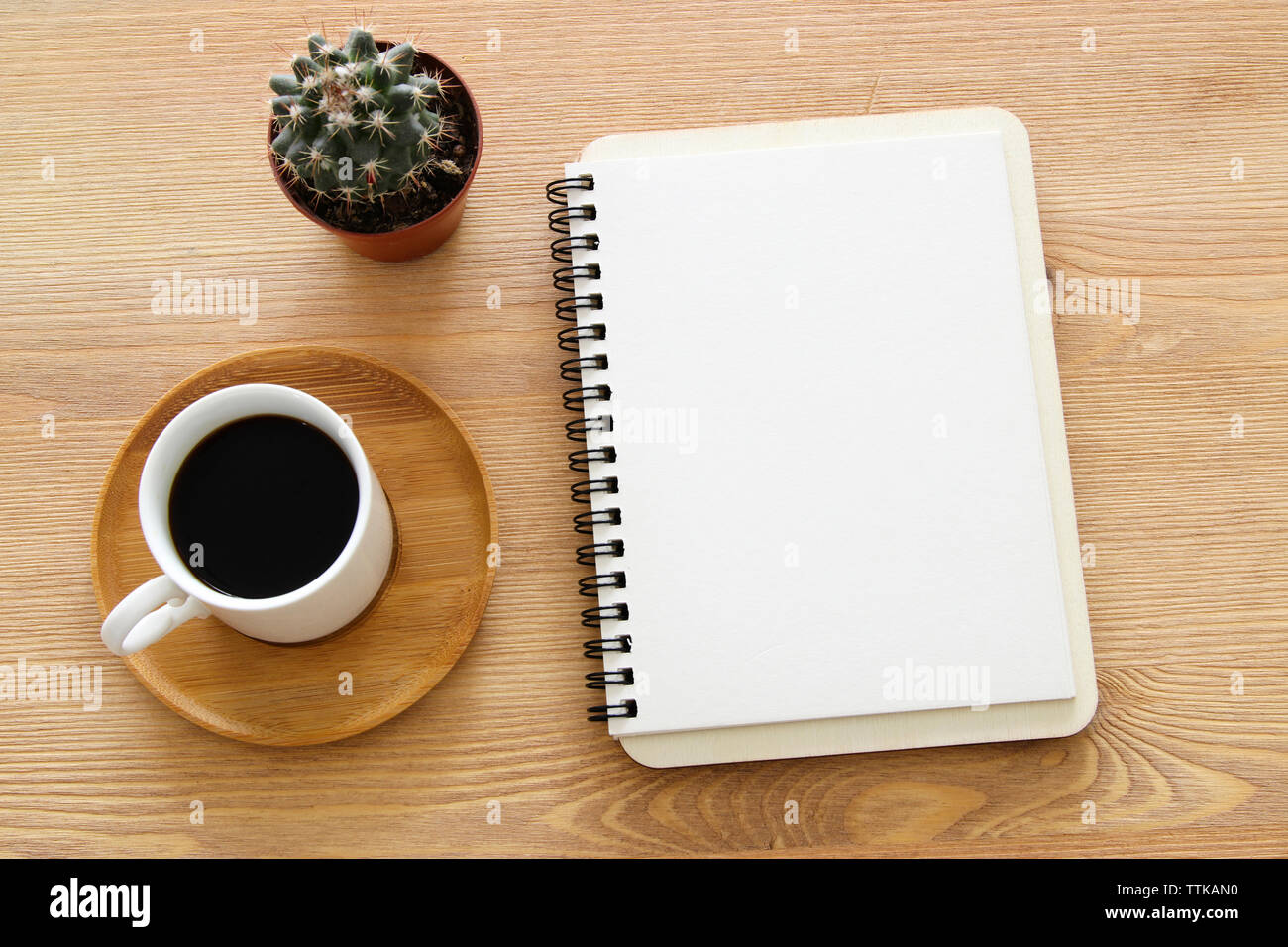 Open notebook with empty pages over wooden old office desk table. Top ...