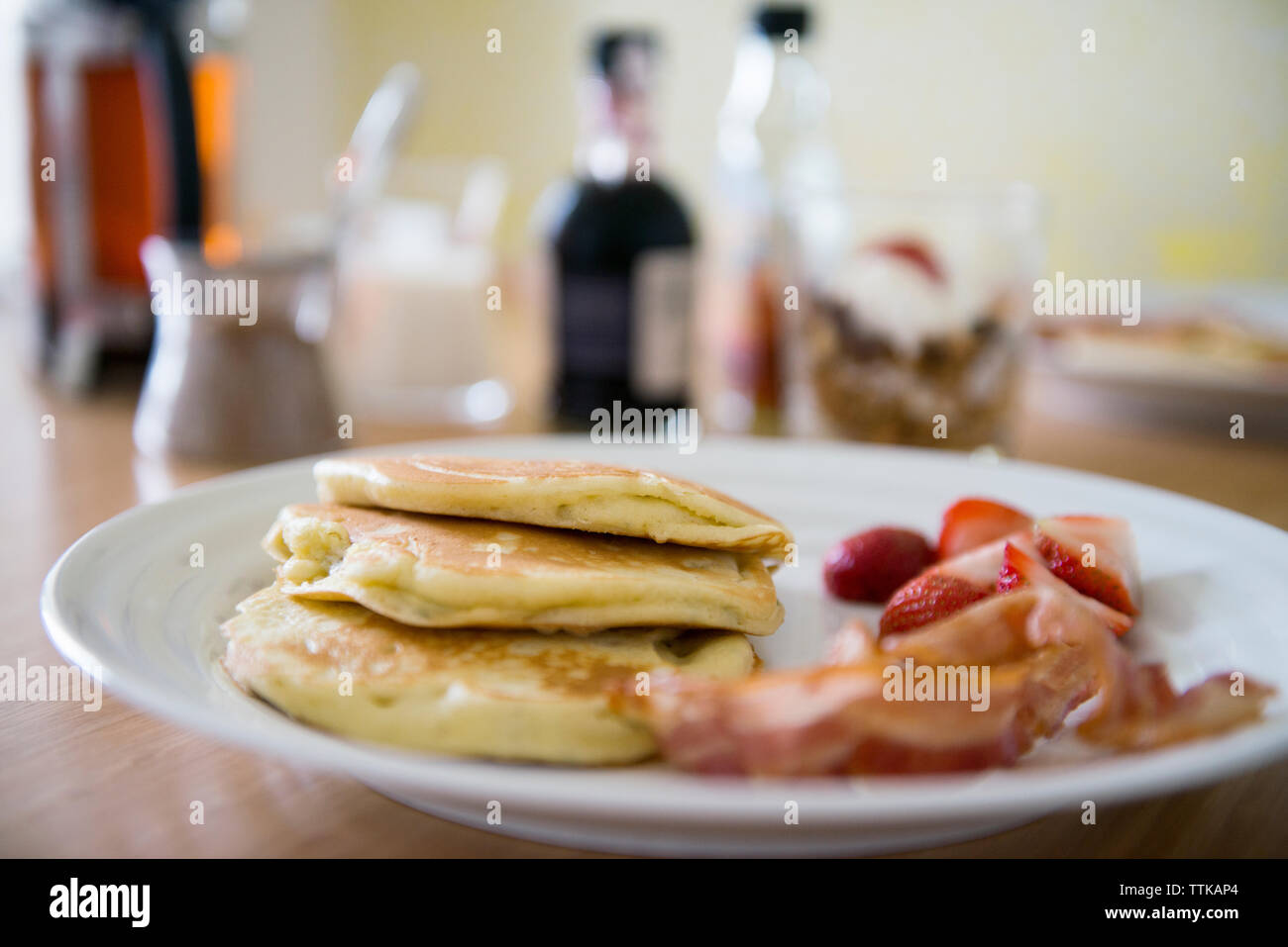 Close-up of pancakes and fruits served in plate on table Stock Photo ...
