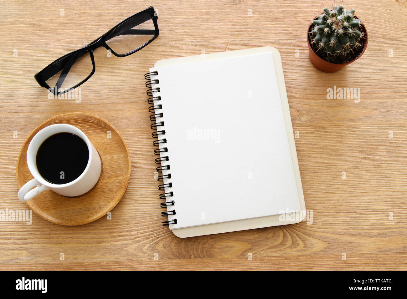 Open notebook with empty pages over wooden old office desk table. Top ...