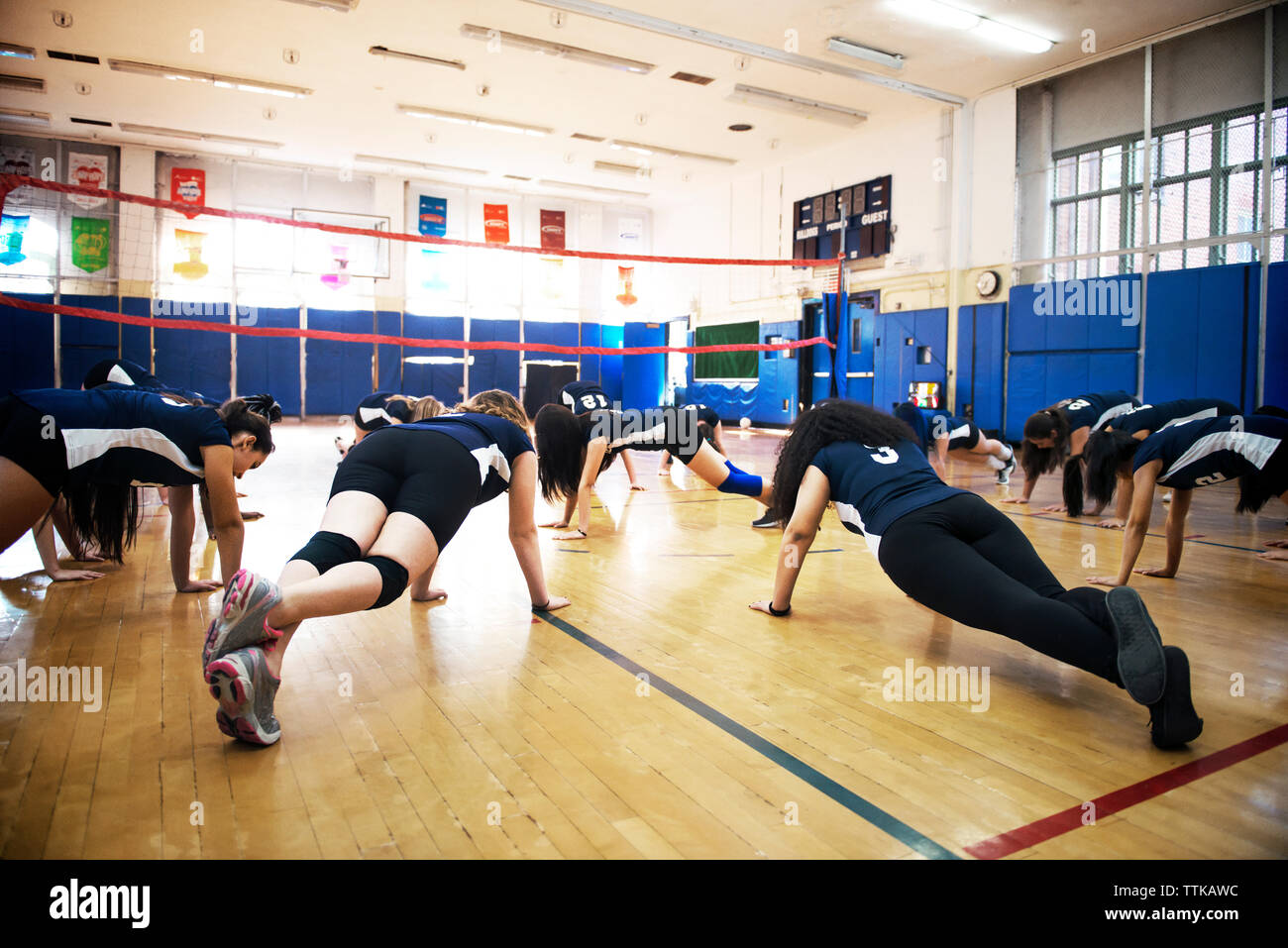 Girls doing warming up exercise on floor Stock Photo - Alamy