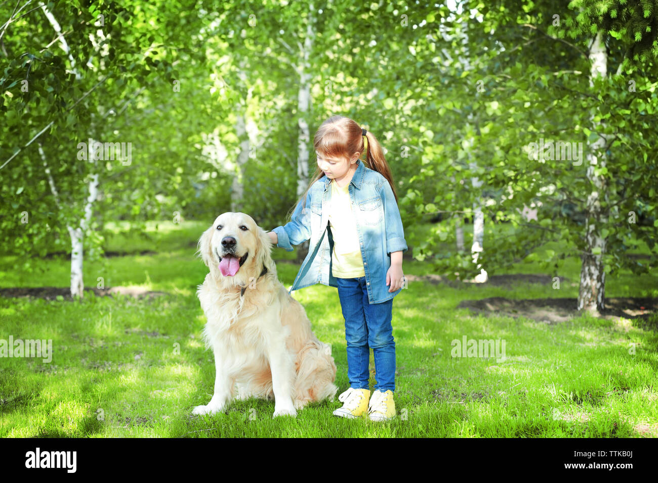 Little girl and big kind dog in the park Stock Photo - Alamy