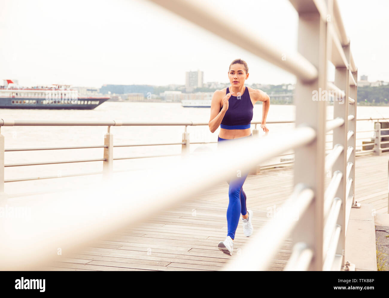 Woman practicing running on bridge hi-res stock photography and images ...
