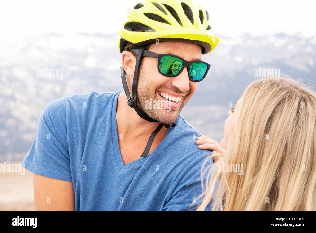 Happy couple talking while standing on mountain Stock Photo - Alamy