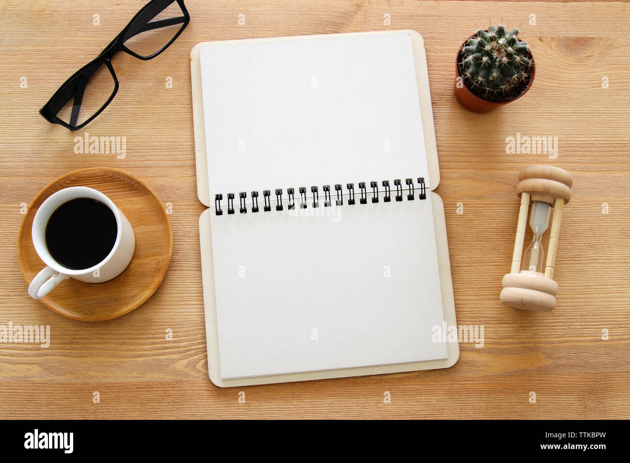 Open notebook with empty pages over wooden old office desk table. Top ...