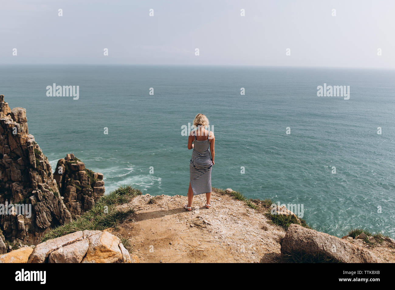 Woman On Cliff Looking Beach High Resolution Stock Photography and ...