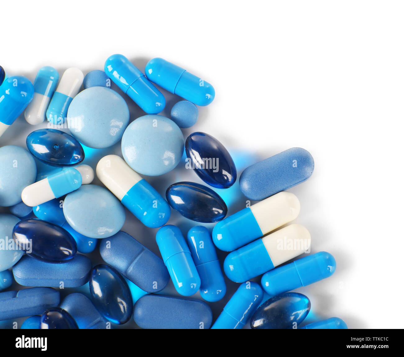Blue pills isolated on white Stock Photo - Alamy