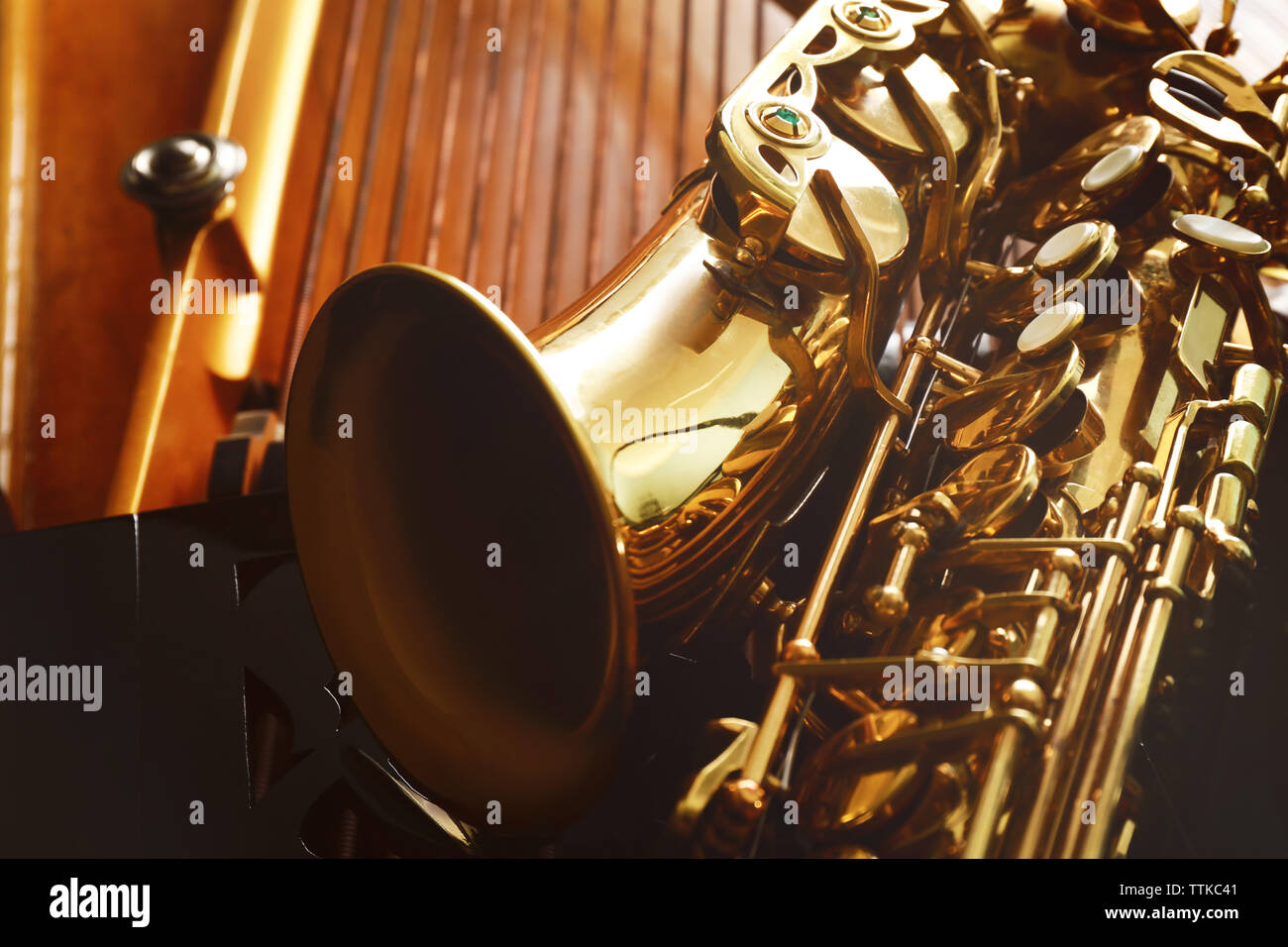 Saxophone lying on the piano, close up Stock Photo - Alamy