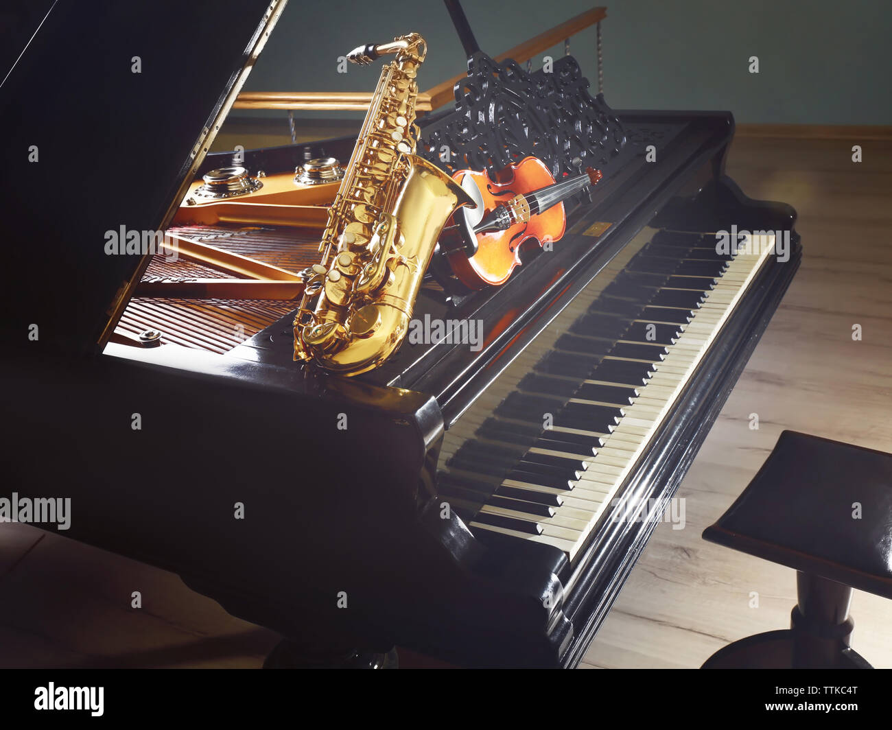Violin and saxophone lying on piano, close up Stock Photo - Alamy