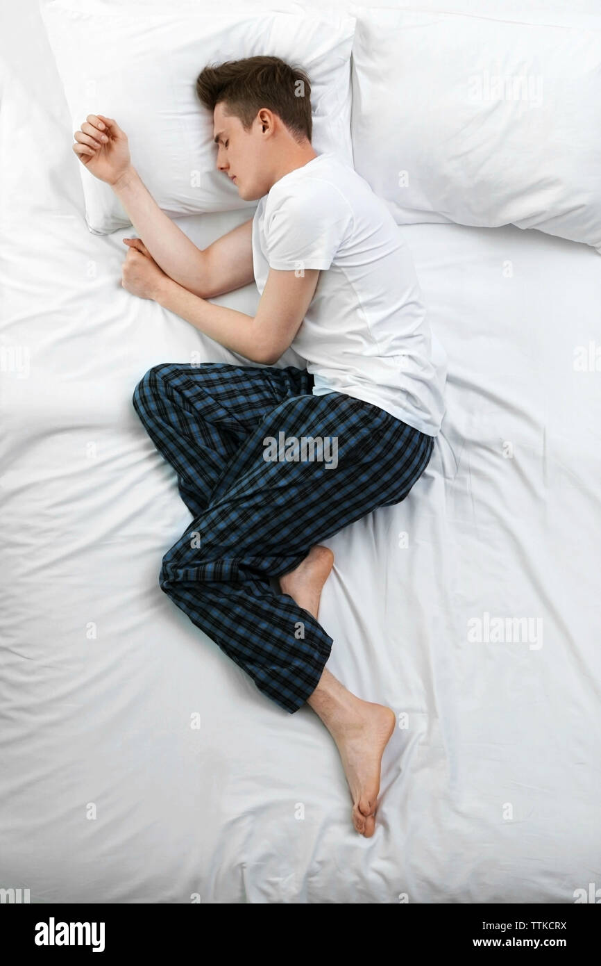 Handsome man in bed, top view Stock Photo - Alamy