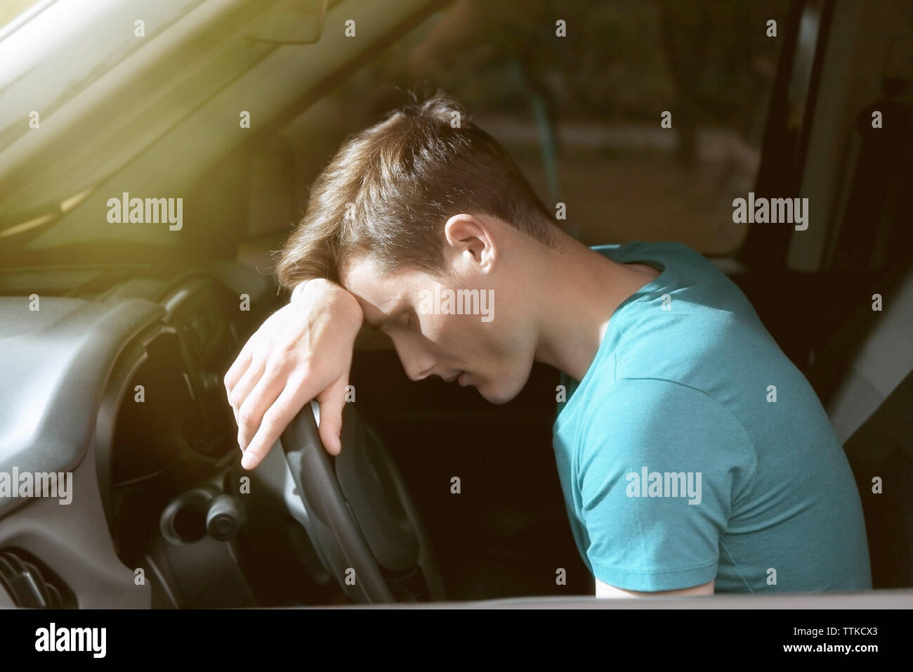 Handsome man falling asleep in car Stock Photo - Alamy