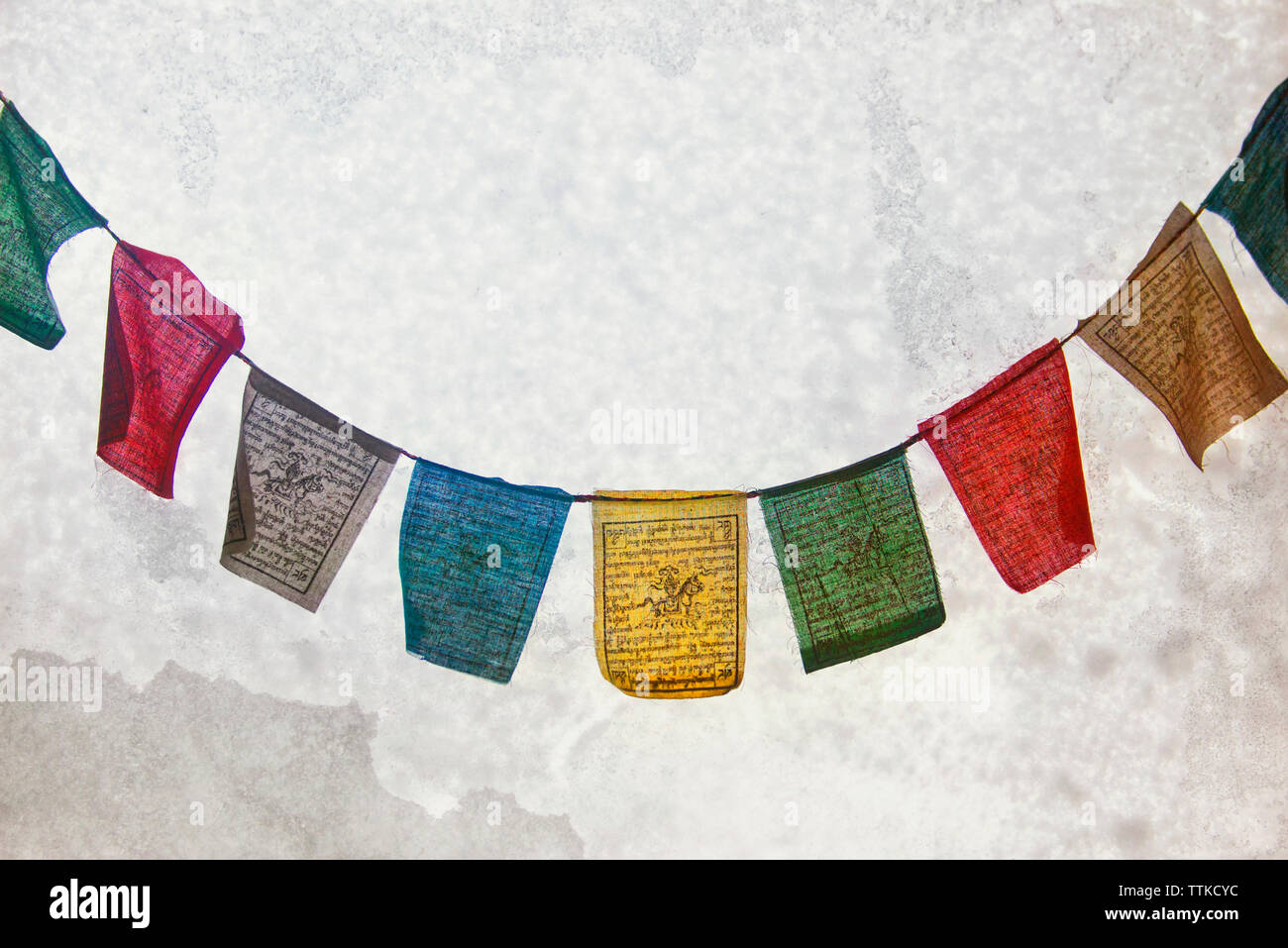 Prayer Flags hanging on frozen window Stock Photo - Alamy