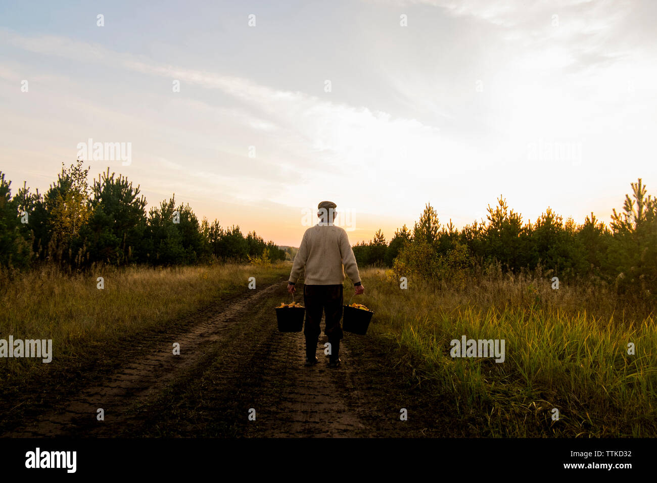 Man with buckets hi-res stock photography and images - Alamy