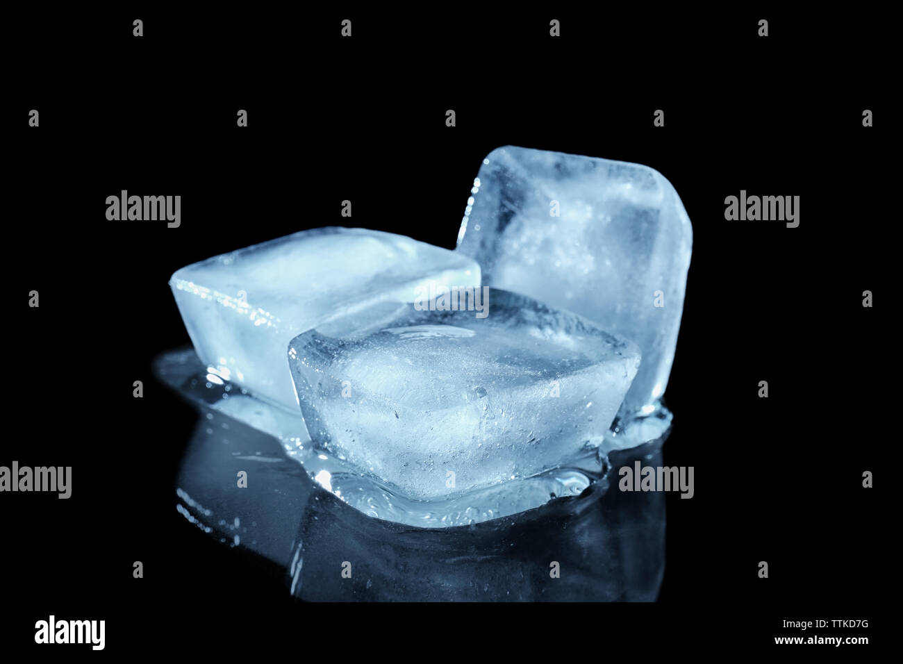 Melting ice cubes on dark background Stock Photo - Alamy