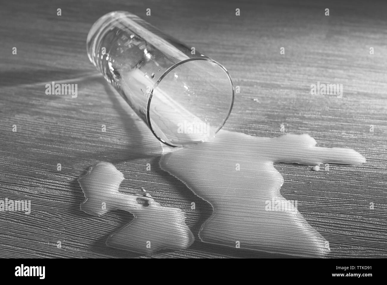 Glass of water spilled on textured background Stock Photo - Alamy