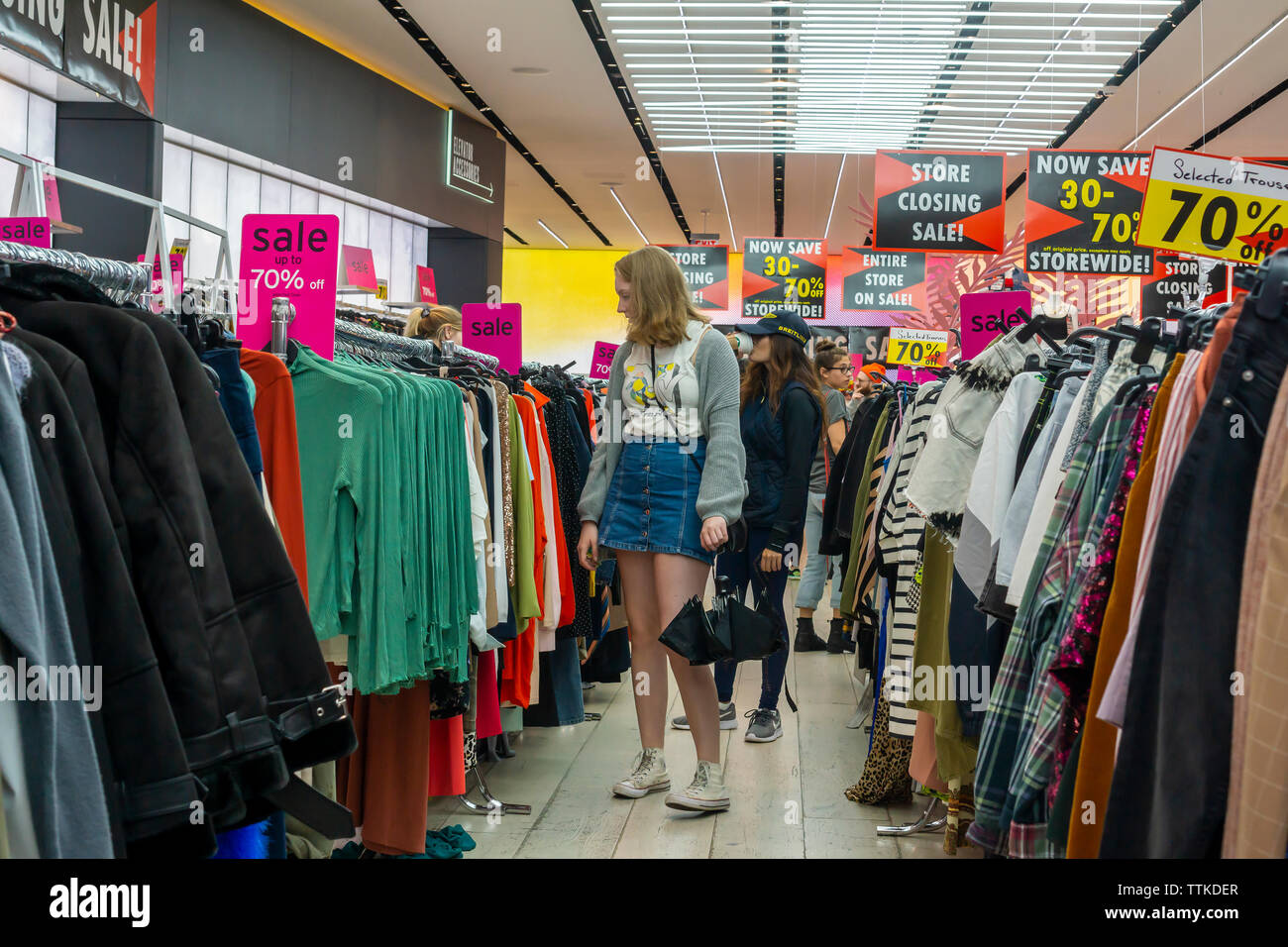 Shoppers browse the sales at the TopShop/TopMan store on Fifth Avenue ...