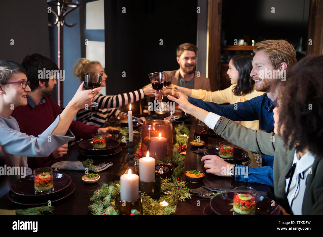 Friends toasting dinner candles hi-res stock photography and images - Alamy