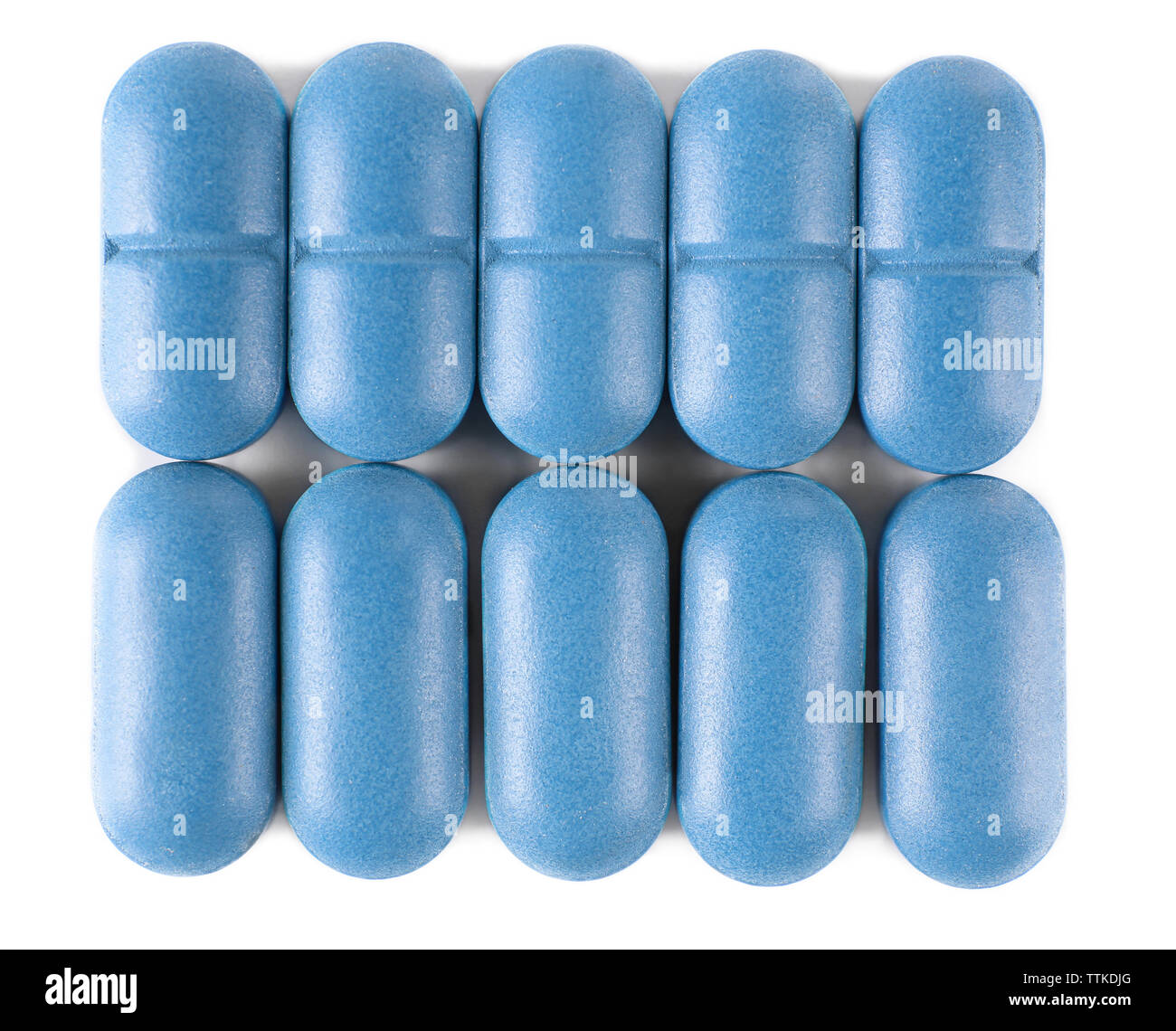 Blue pills on white background Stock Photo - Alamy
