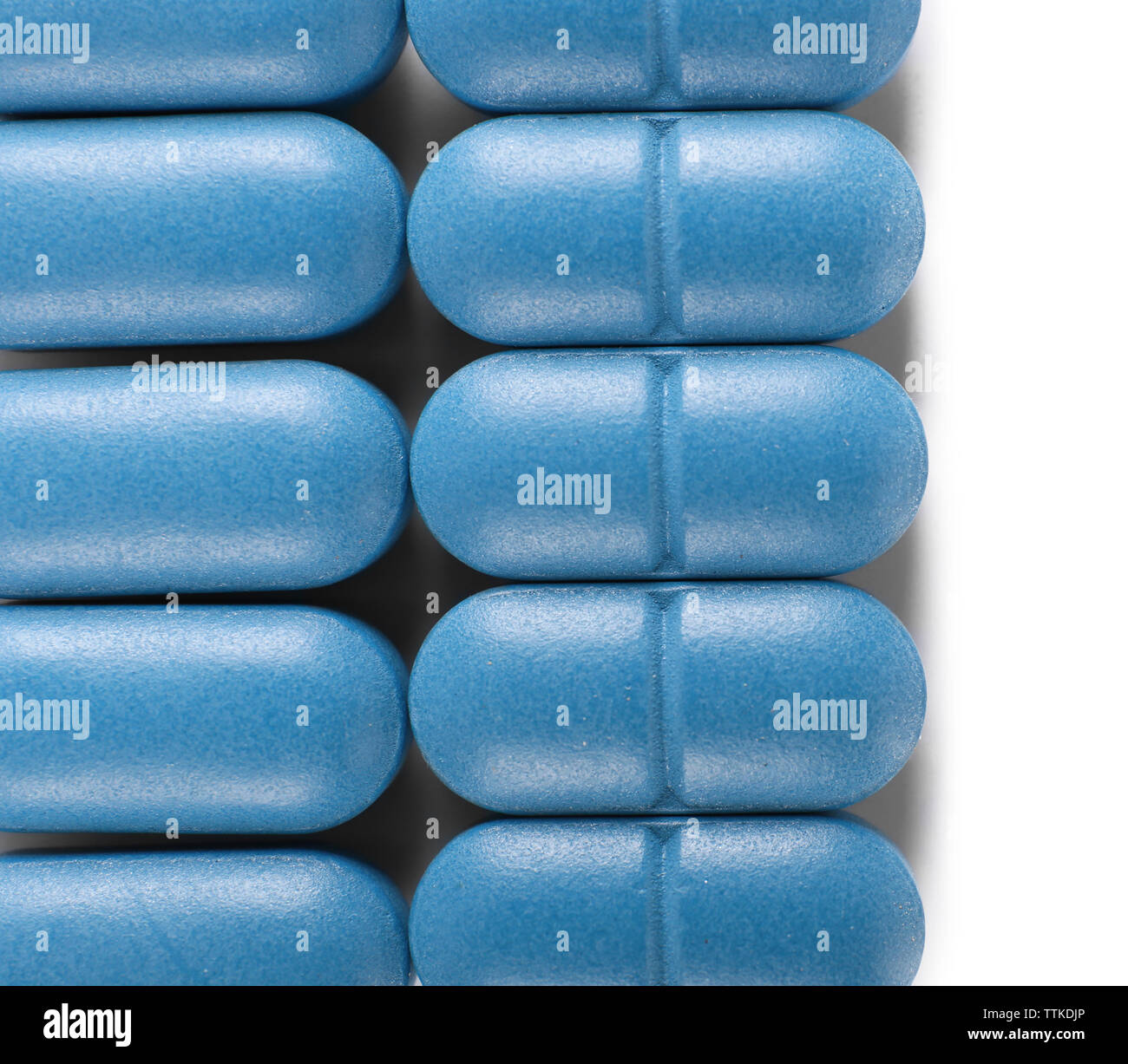 Blue pills on white background Stock Photo - Alamy
