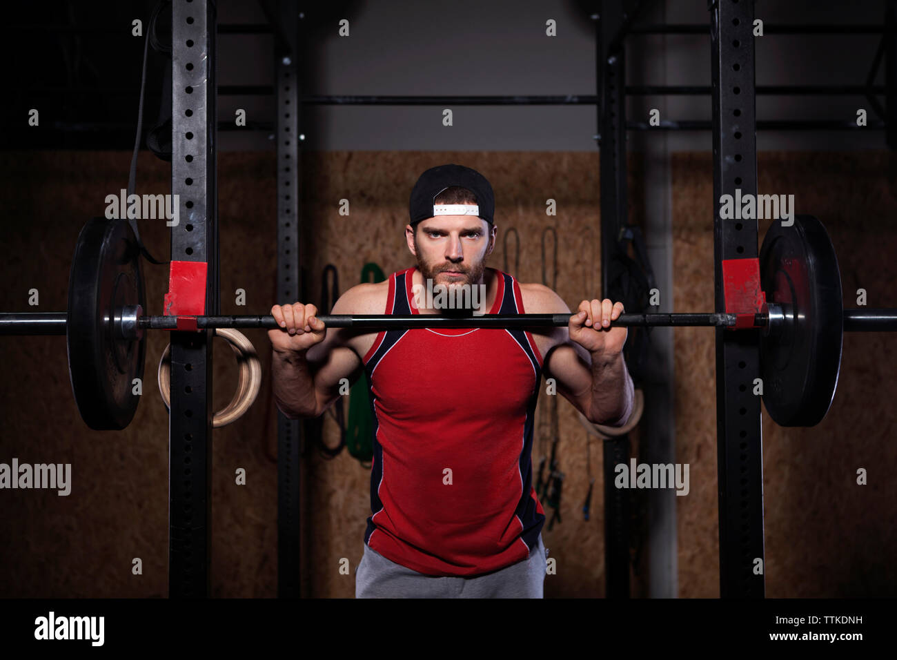 Portrait of man lifting barbells in gym Stock Photo - Alamy