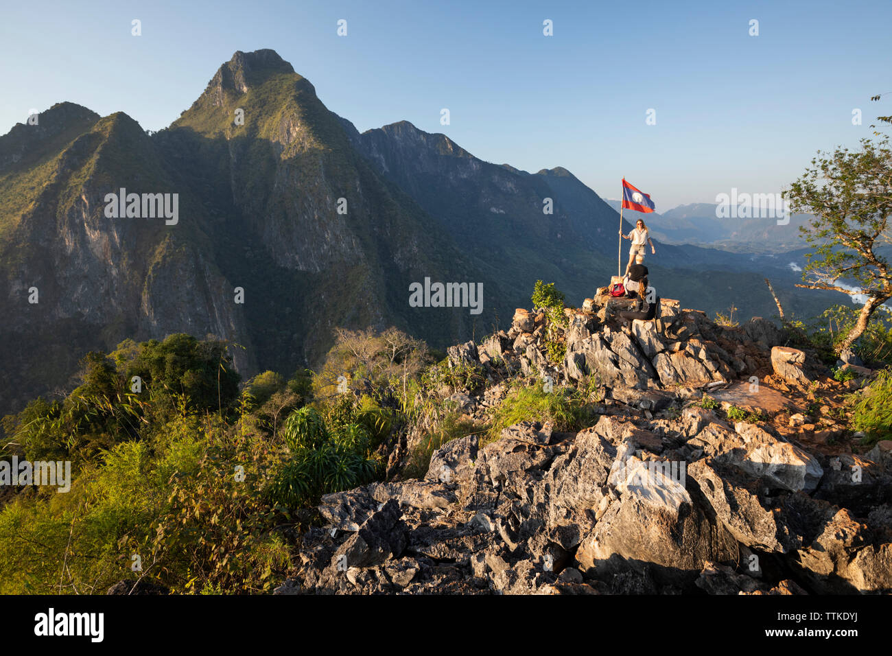 Top of the Pha Daeng Peak Viewpoint with Laos flag and karsk peaks ...