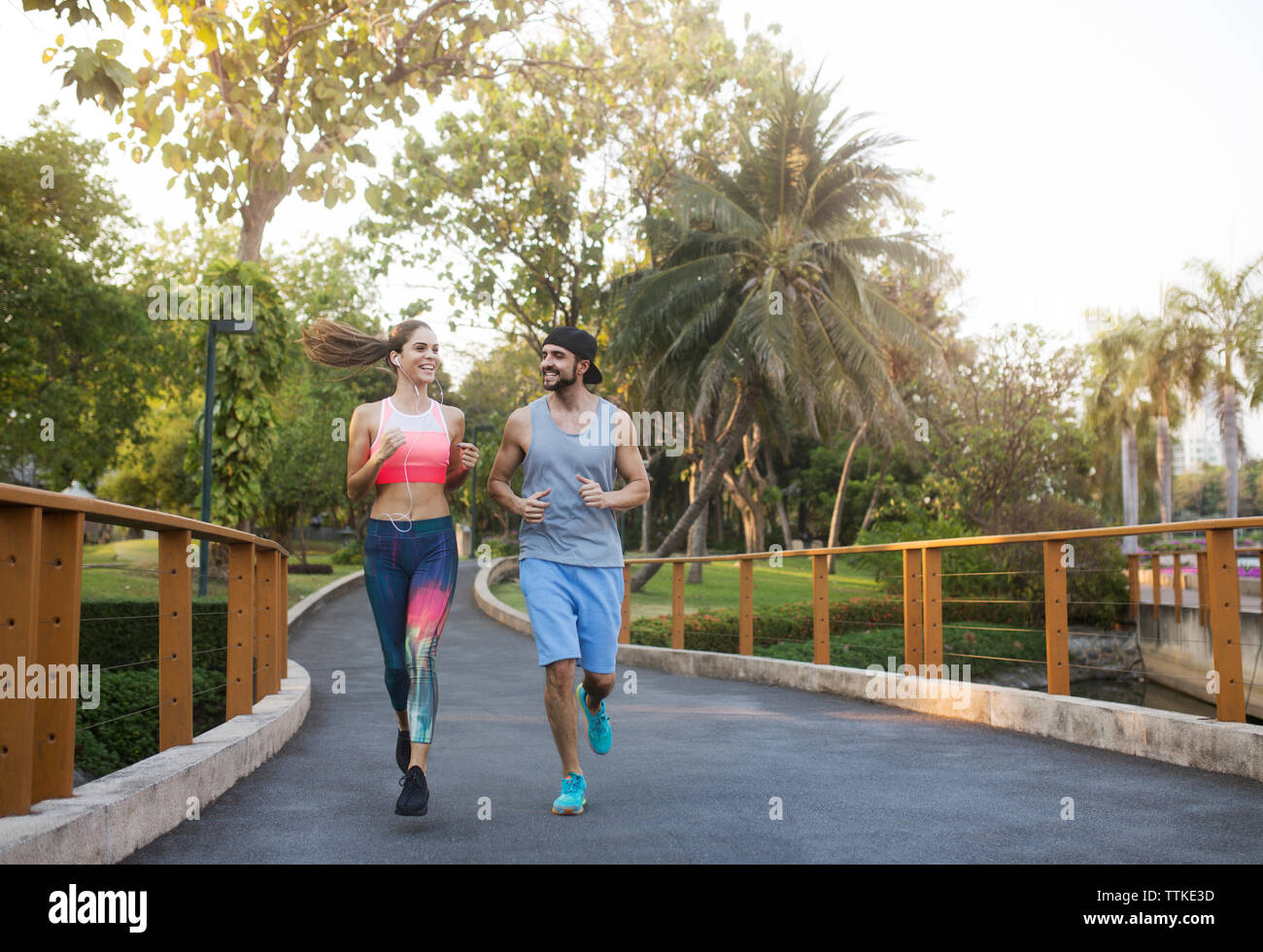 Mid adult couple smiling park hi-res stock photography and images - Alamy