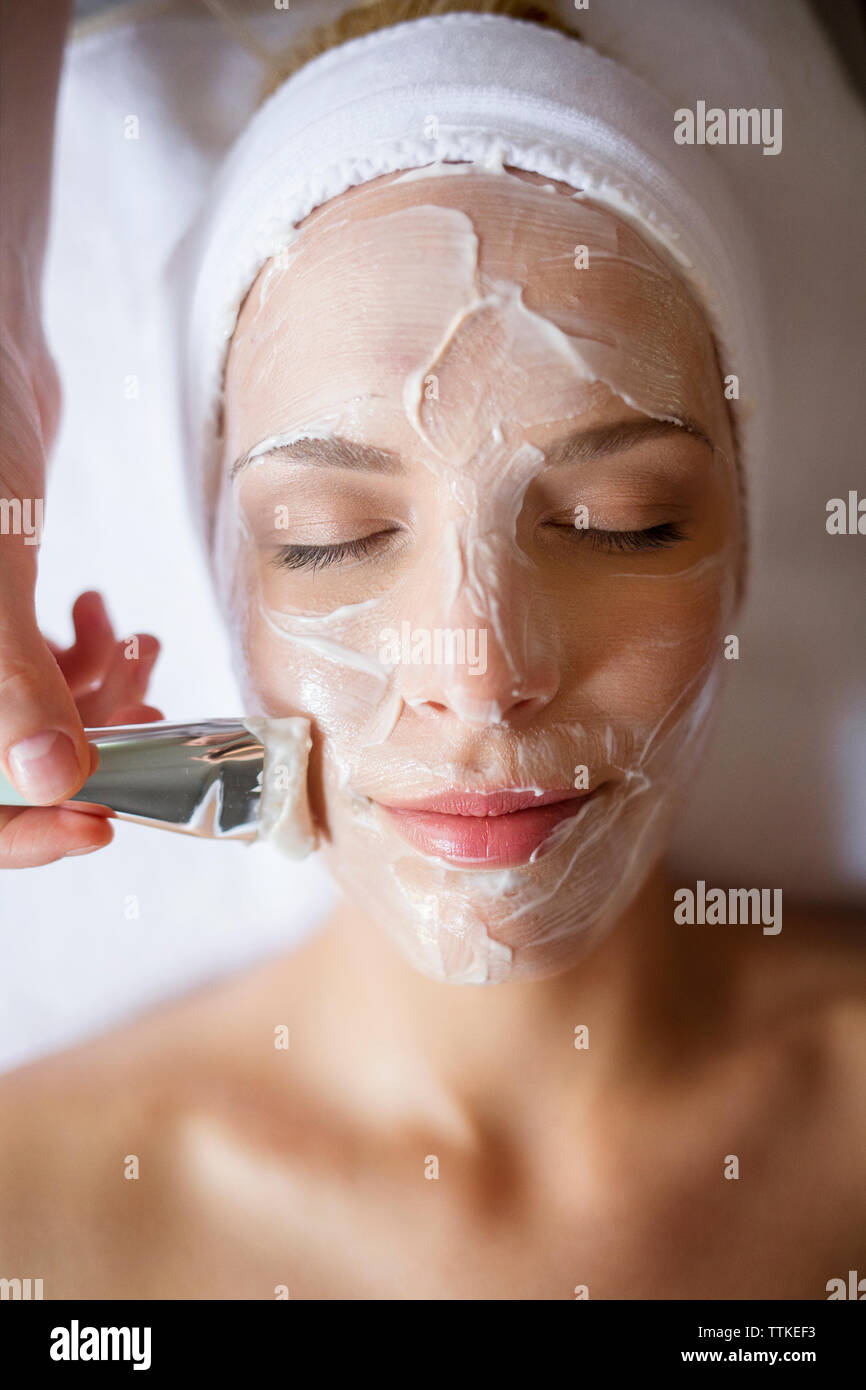 Overhead view of facial mask being applied on woman's face in spa Stock ...