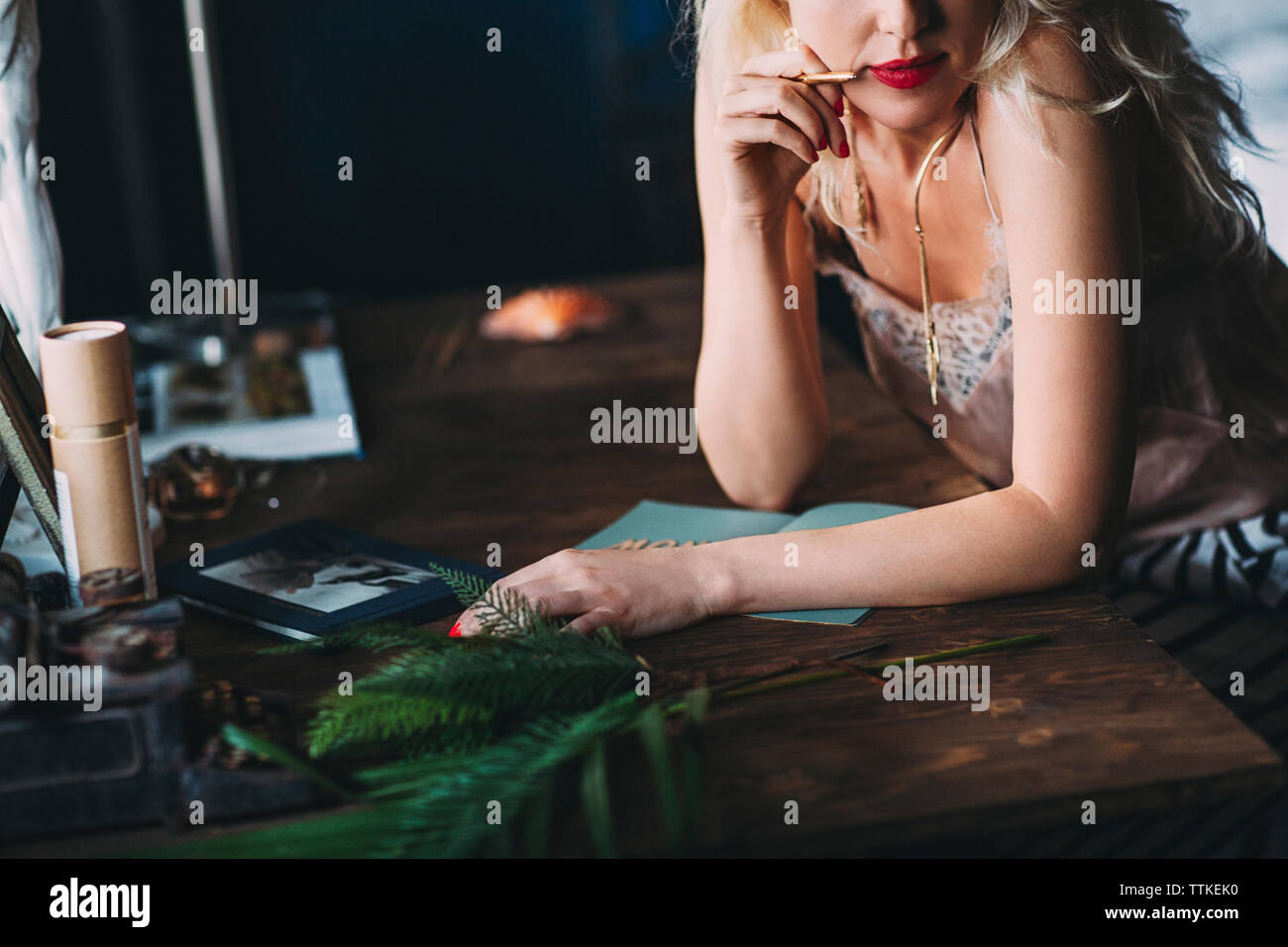 Beautiful woman sitting table hi-res stock photography and images - Alamy