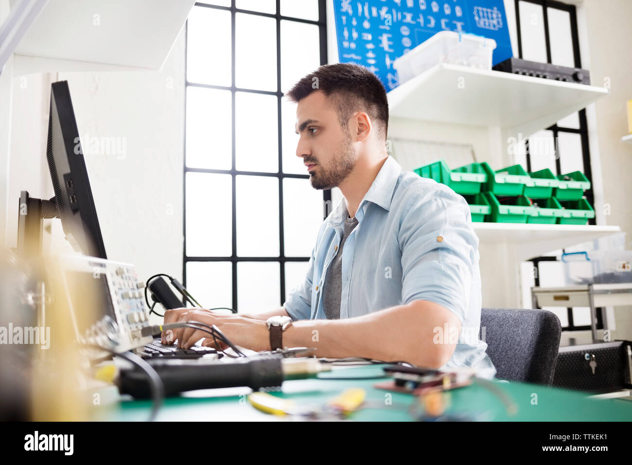 Engineer using computer in electronic laboratory Stock Photo - Alamy