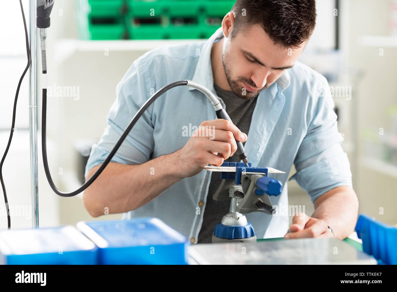 Concentrated engineer working on circuit board in electronic laboratory ...