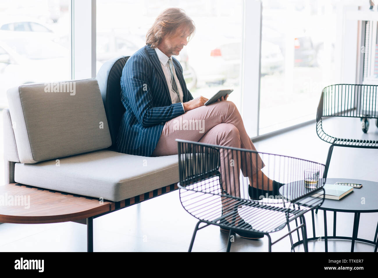 Midsection of mature businessman using tablet computer in office Stock ...