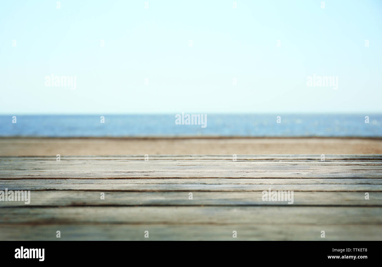 Wooden pier with blue sea and sky background Stock Photo - Alamy