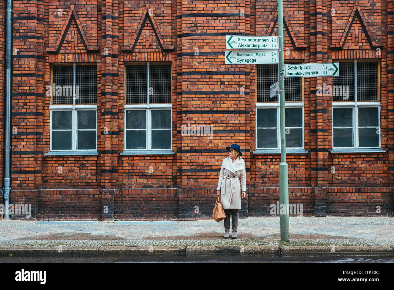 Woman standing bus stop hi-res stock photography and images - Alamy