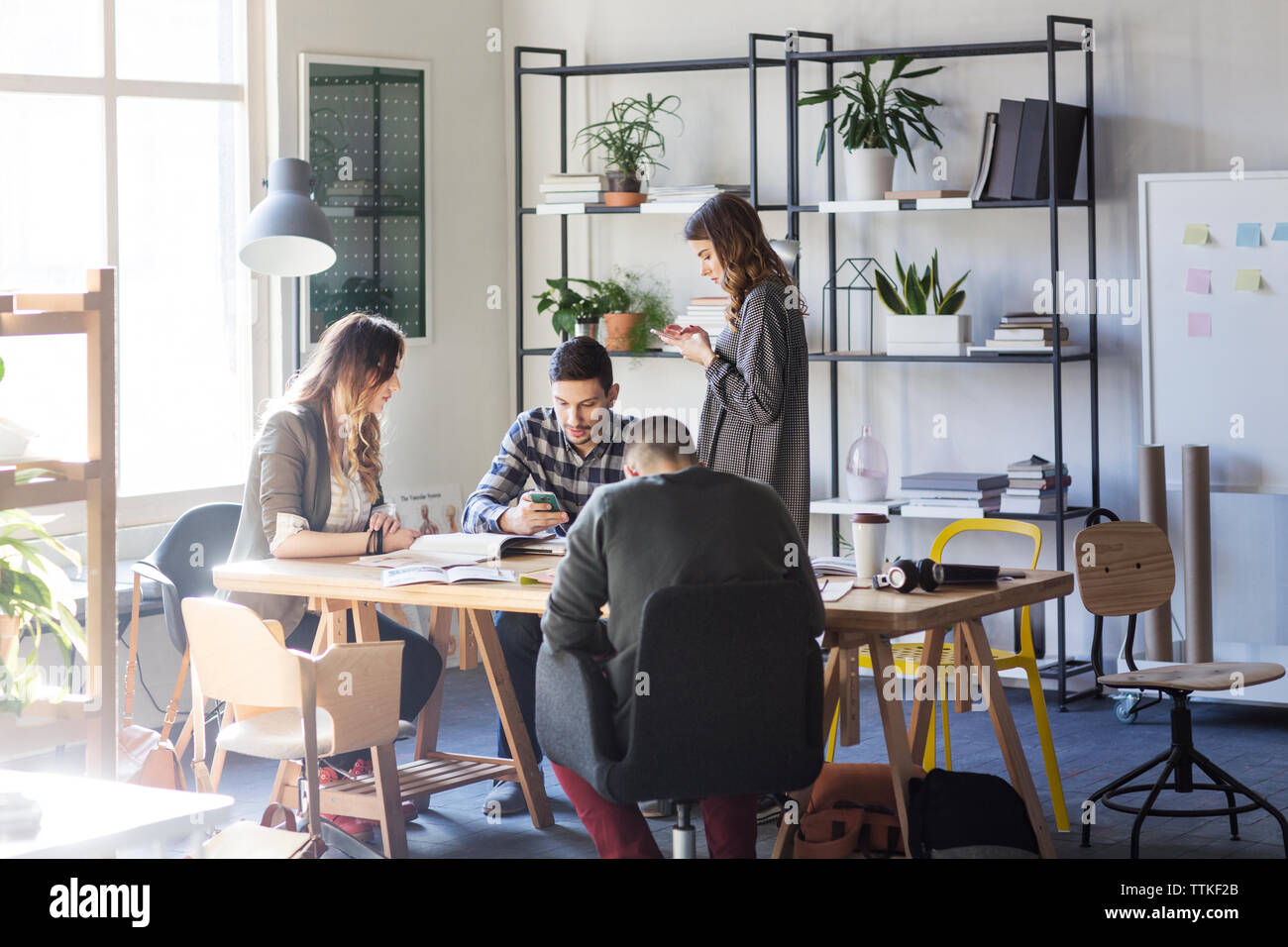 Students using smart phones while studying in classroom Stock Photo - Alamy