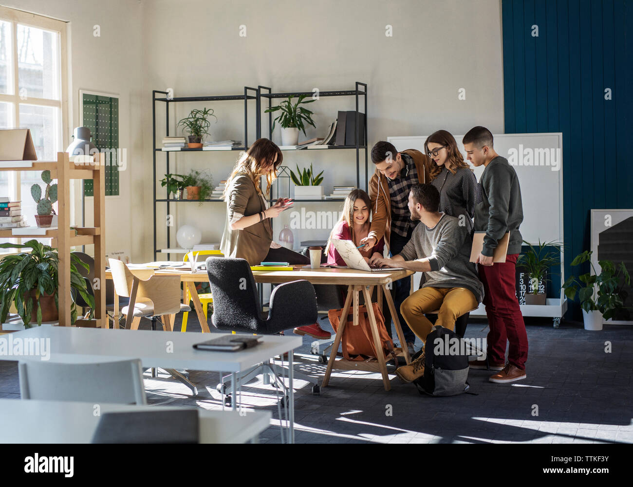 Students using laptop computer while discussing in classroom Stock ...