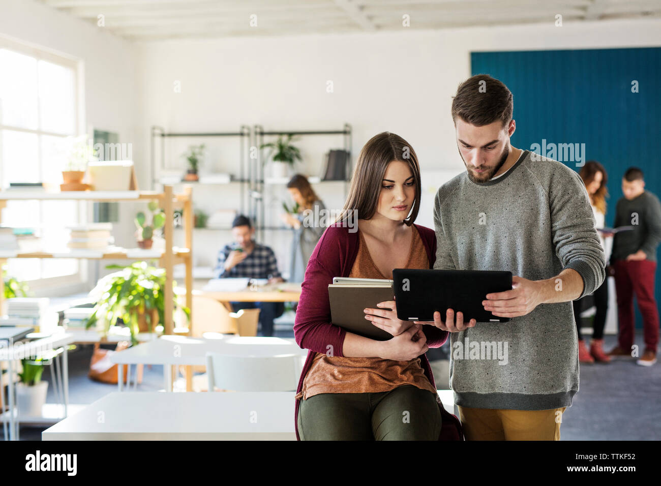 Man showing laptop computer to friend in classroom Stock Photo - Alamy Man showing laptop computer to friend in classroom Stock Photo - Alamy