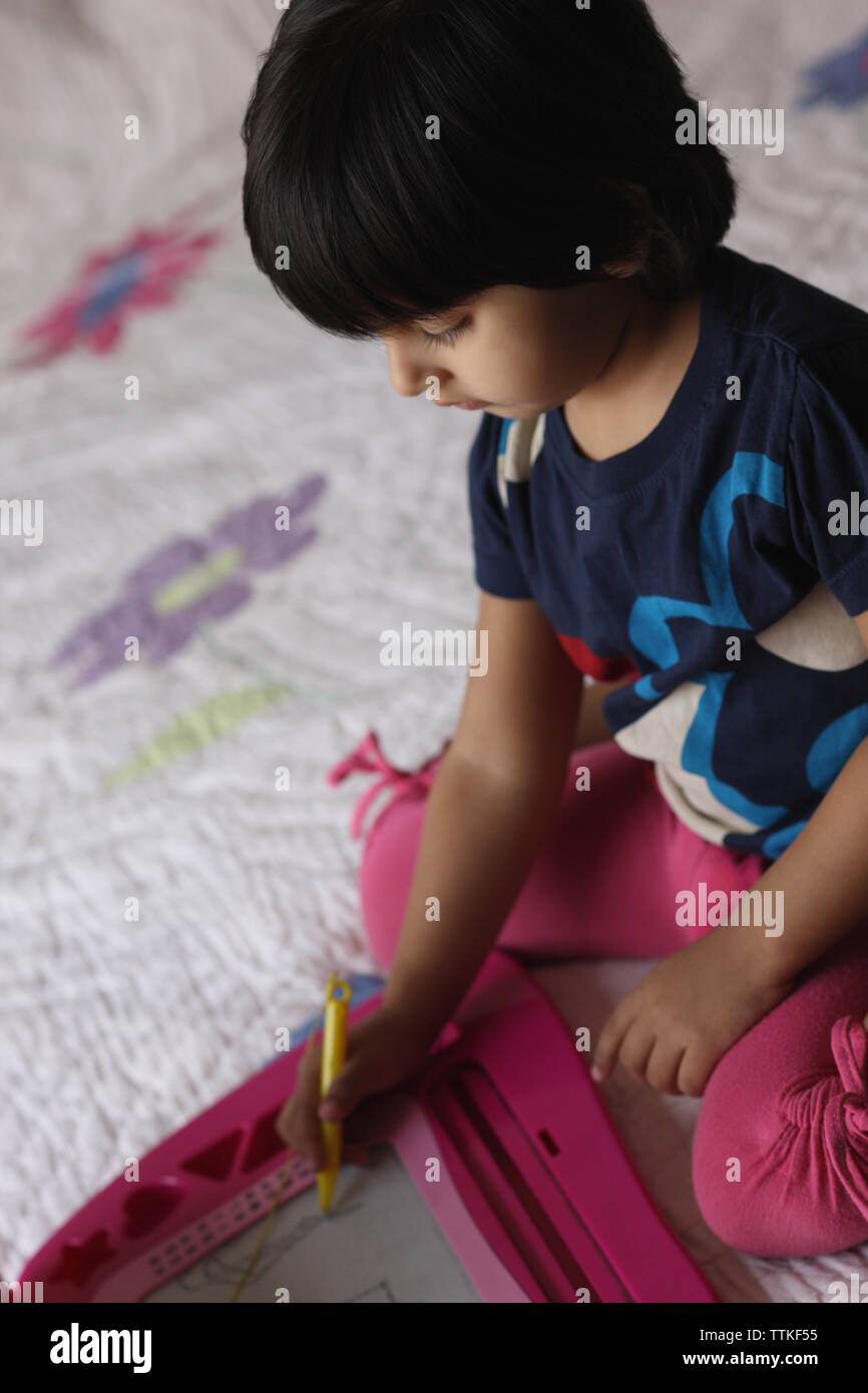 Girl drawing on a magna doodle Stock Photo - Alamy