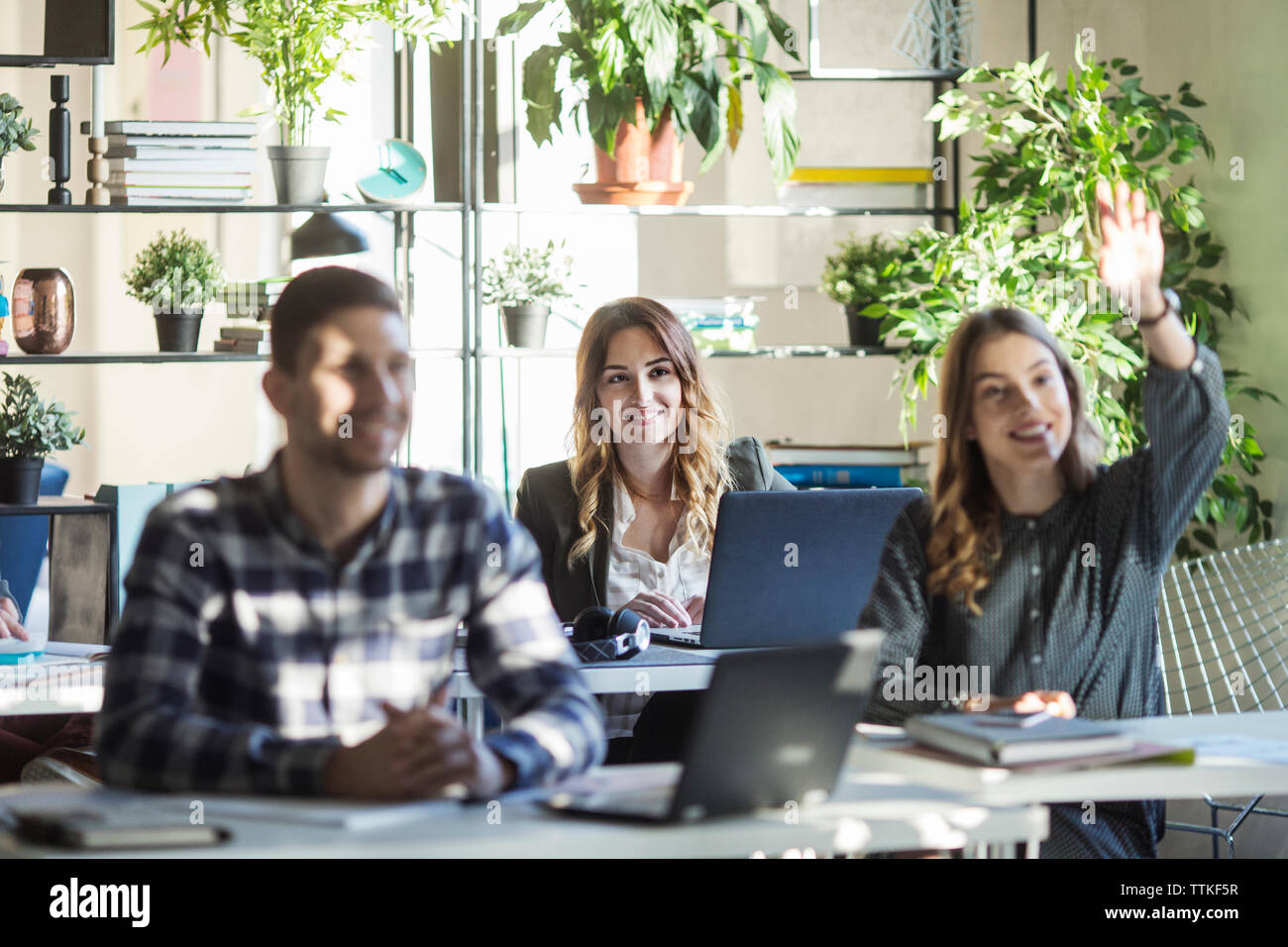 Smiling students during lesson in classroom Stock Photo - Alamy