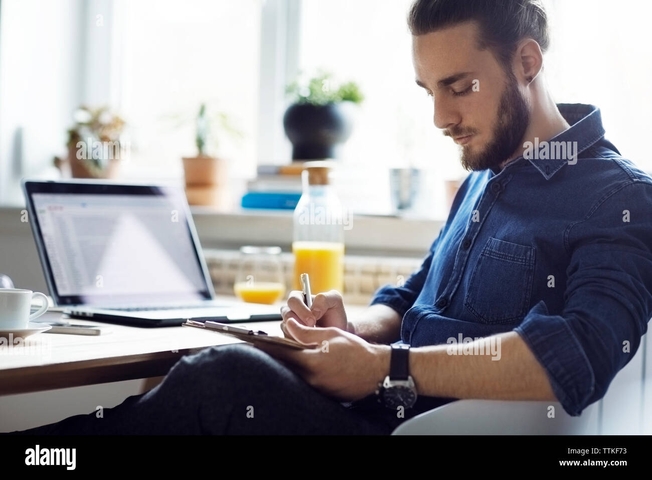 Man writing sitting table hi-res stock photography and images - Alamy