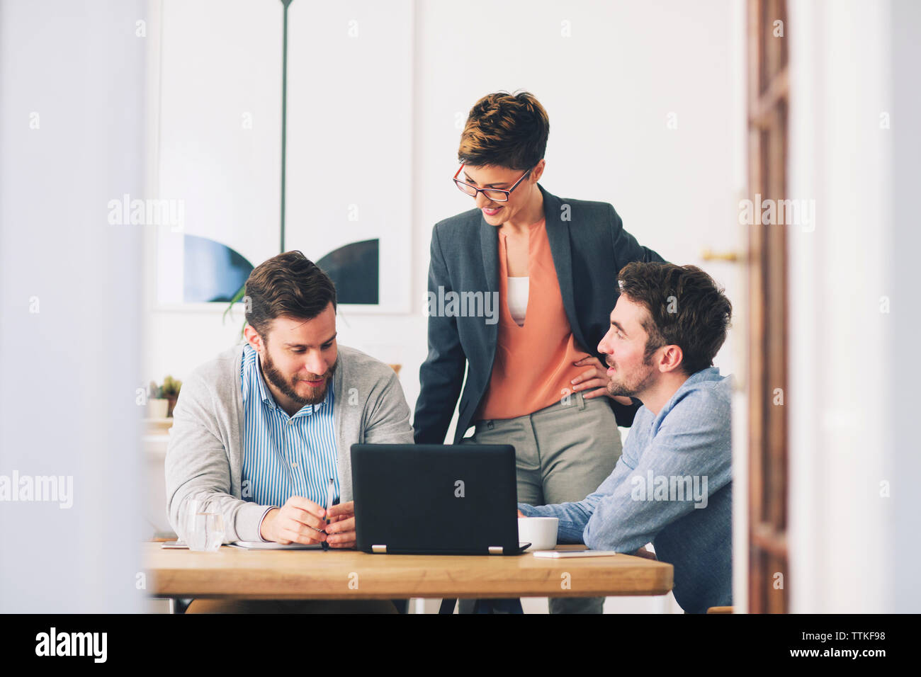 Colleagues talking in office Stock Photo - Alamy