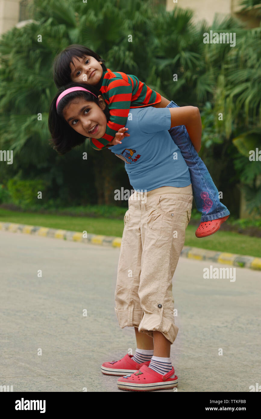 Girl riding piggyback hi-res stock photography and images - Alamy