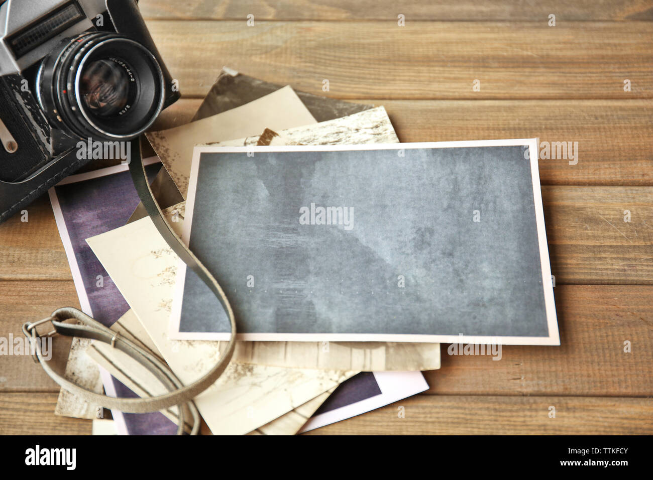 Vintage photos with camera on wooden background Stock Photo - Alamy