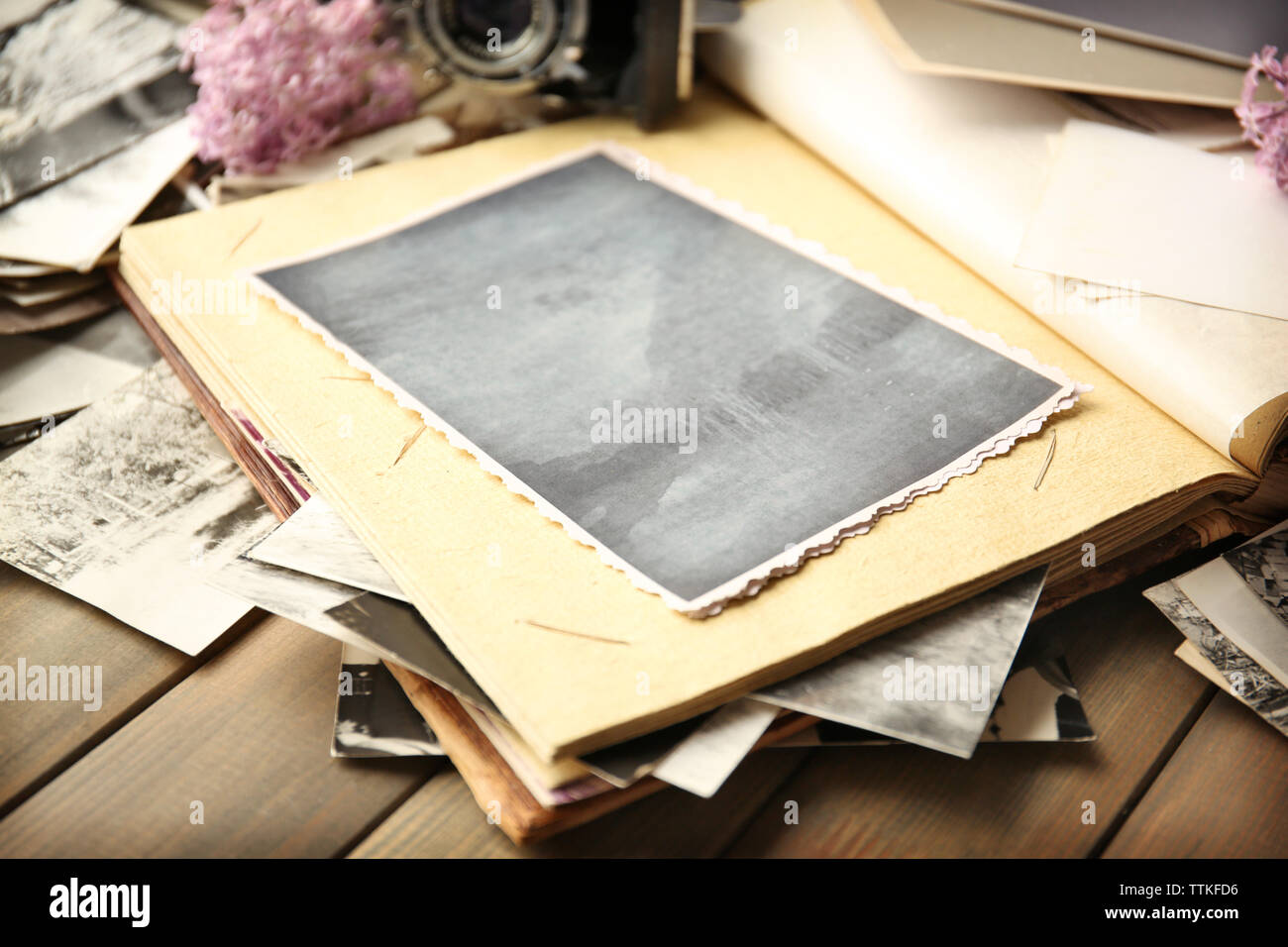 Vintage photos with camera and lilac on wooden background Stock Photo ...