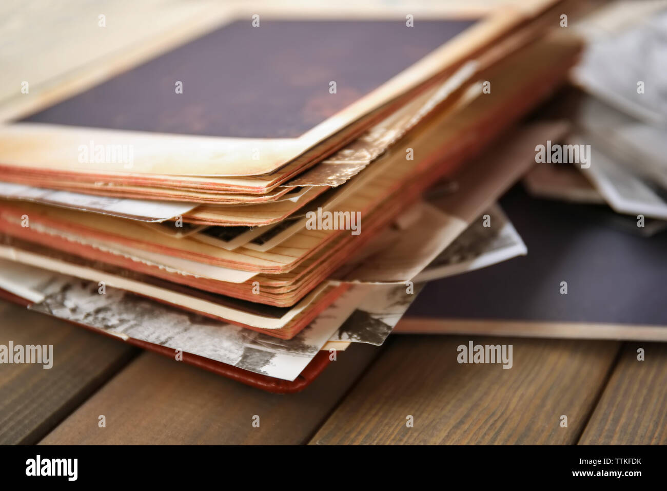 Album with vintage photos on wooden background Stock Photo - Alamy