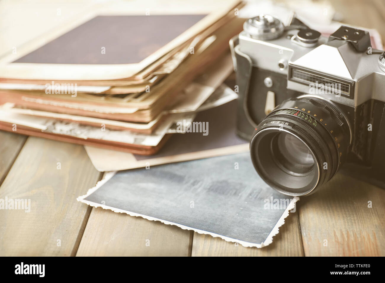 Album with vintage photos and camera on wooden background Stock Photo ...