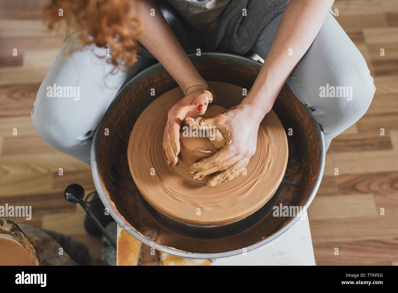 Low section of female potter molding clay in workshop Stock Photo - Alamy