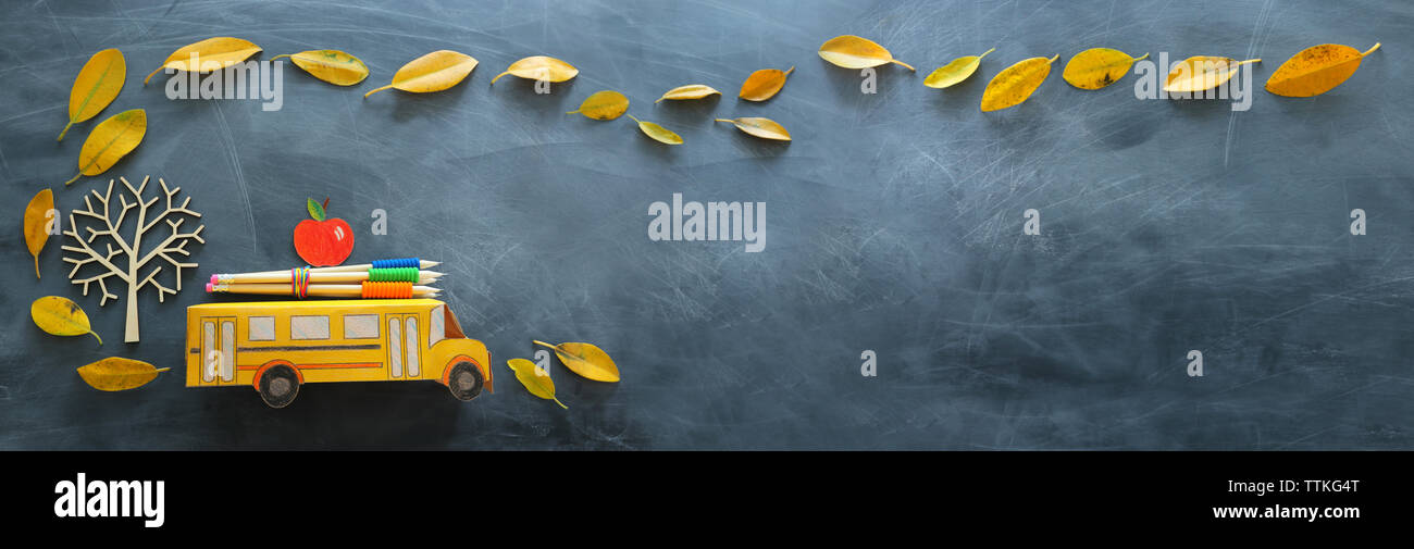Back to school concept. Top view banner of cardboard school bus, apple ...