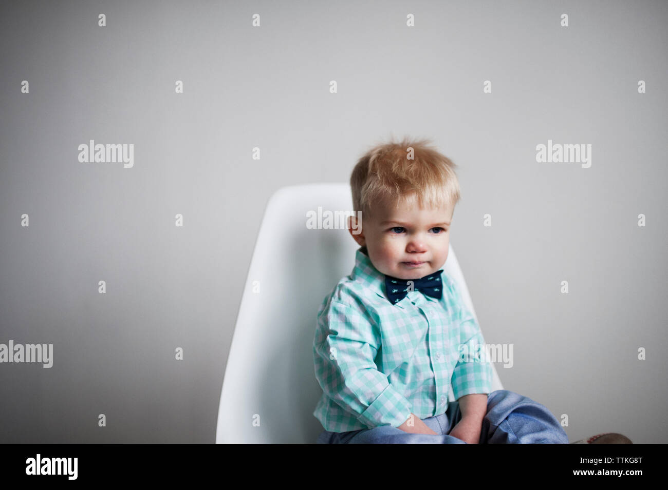Crying Baby Boy Sitting On Chair High Resolution Stock Photography and ...