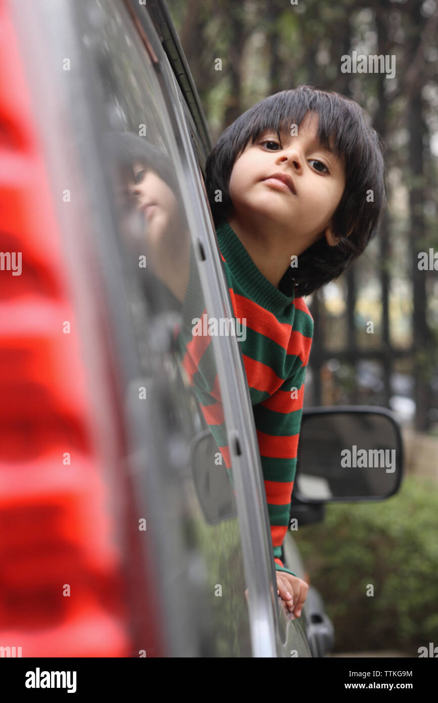 Girl leaning out of window of a car Stock Photo - Alamy