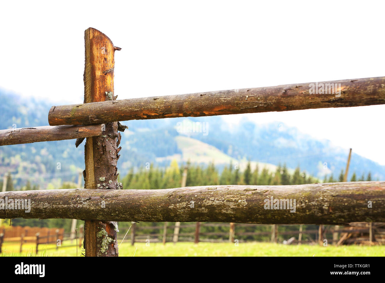 Wooden fence on mountain forest background Stock Photo - Alamy